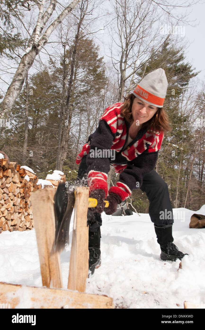 Woman chopping fire wood Stock Photo - Alamy