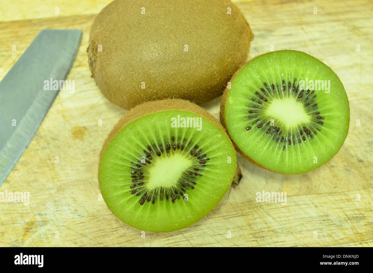 Whole kiwi fruit and his sliced segments isolated on white background ...