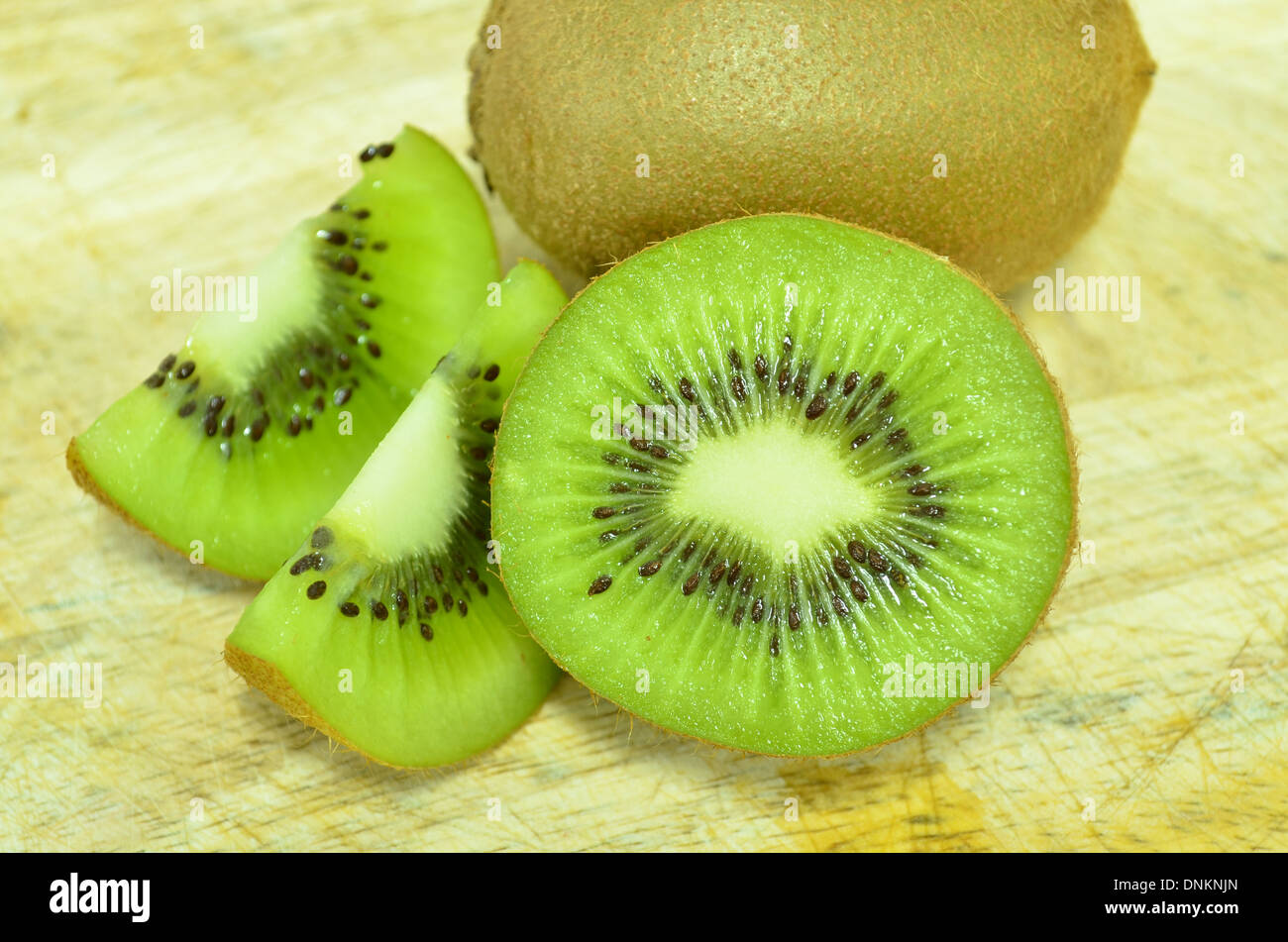 Whole kiwi fruit and his sliced segments isolated on white background ...