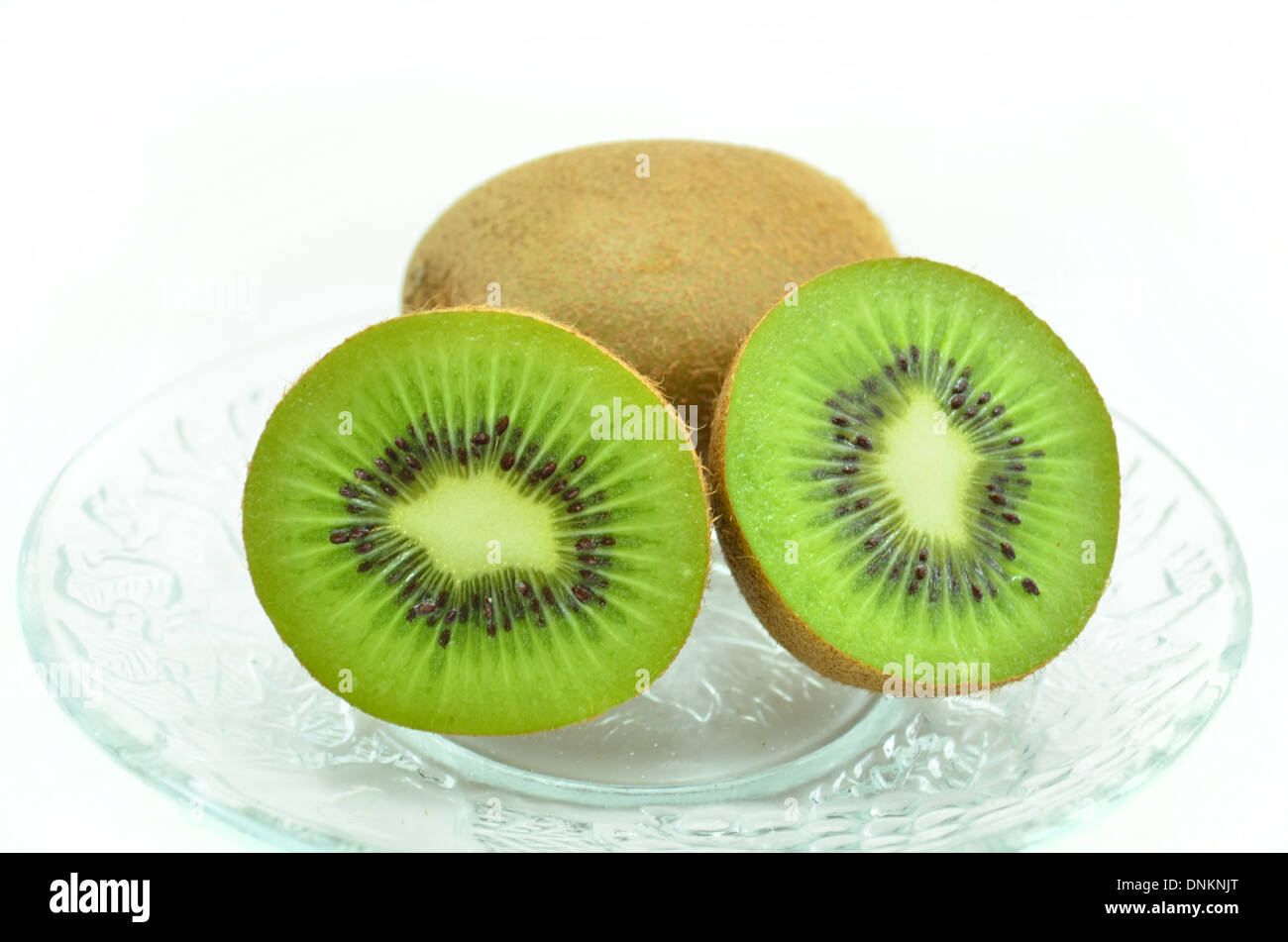 Whole kiwi fruit and his sliced segments isolated on white background ...