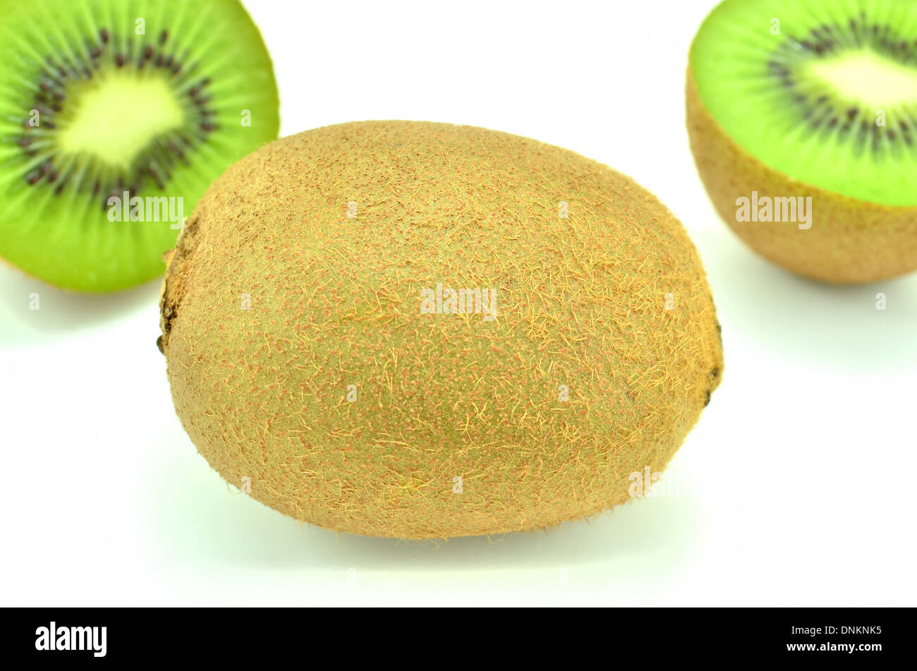 Whole kiwi fruit and his sliced segments isolated on white background ...