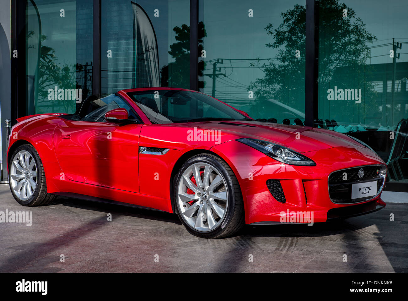 Jaguar F type. Full length side view of a red British convertible ...