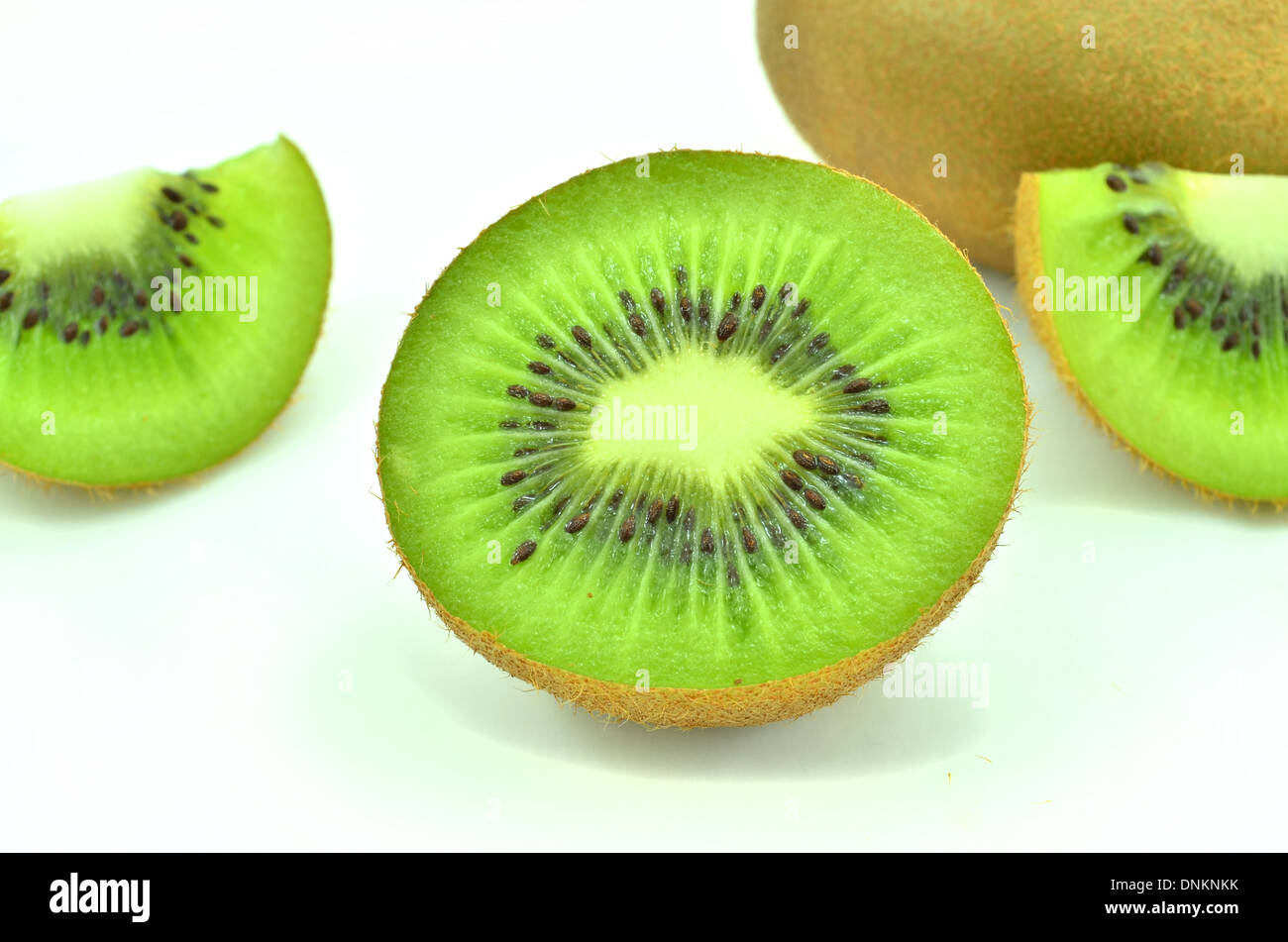 Whole kiwi fruit and his sliced segments isolated on white background ...