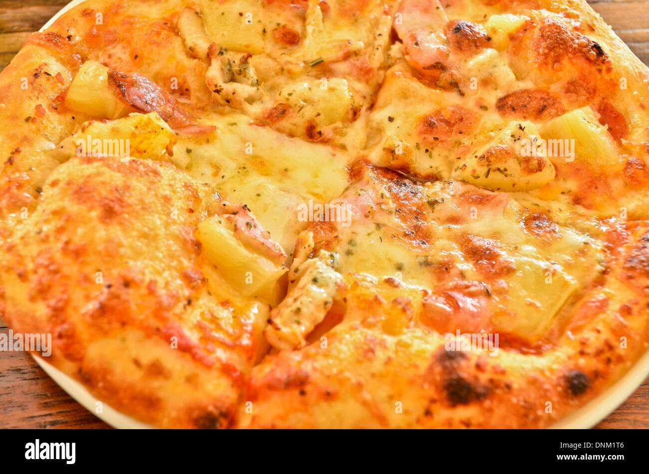 delicious hawaiian rustic style pizza made with fresh pineapples,ham ...
