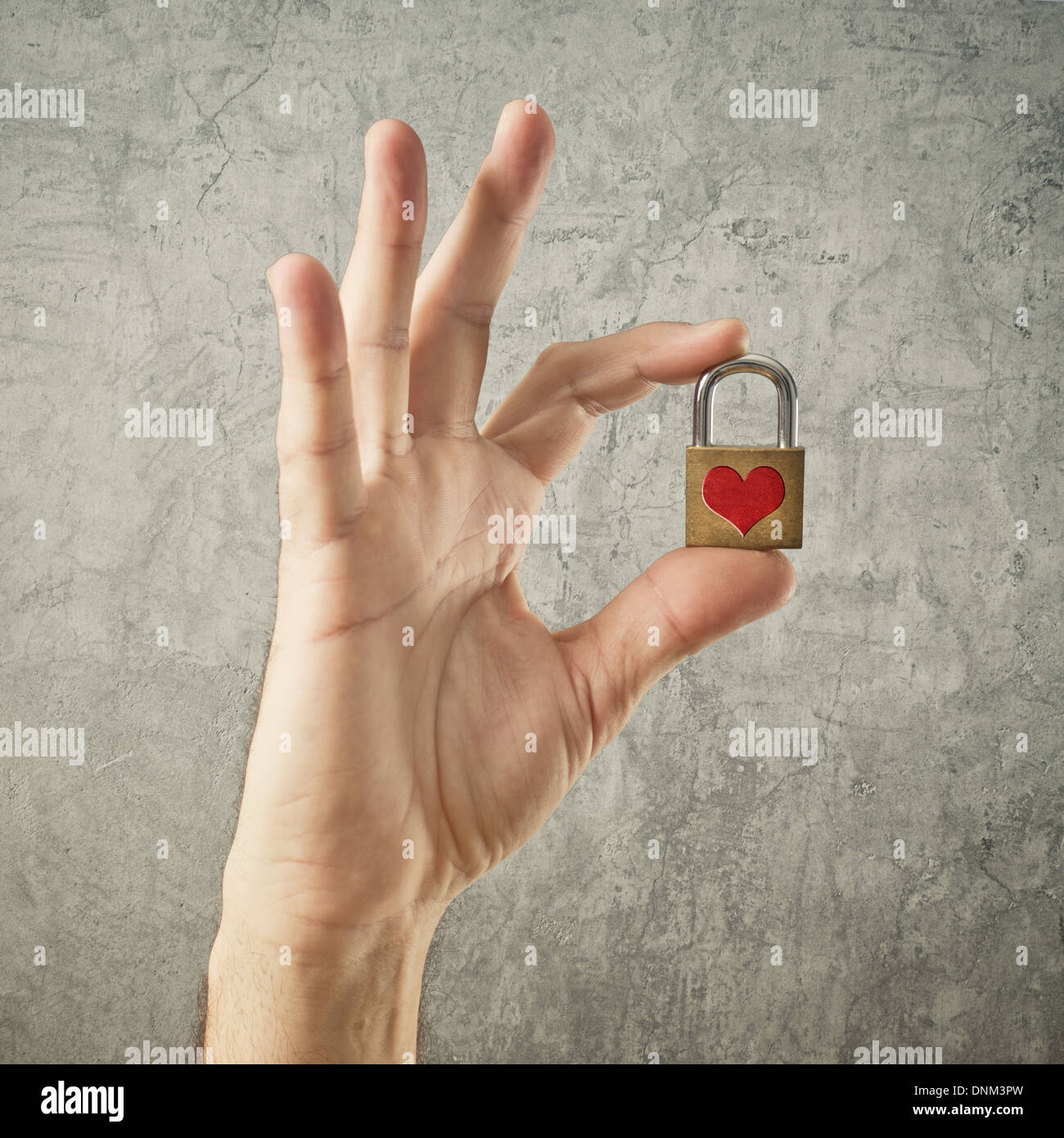 Hand holding locked padlock with heart shape. Locked emotions concept ...