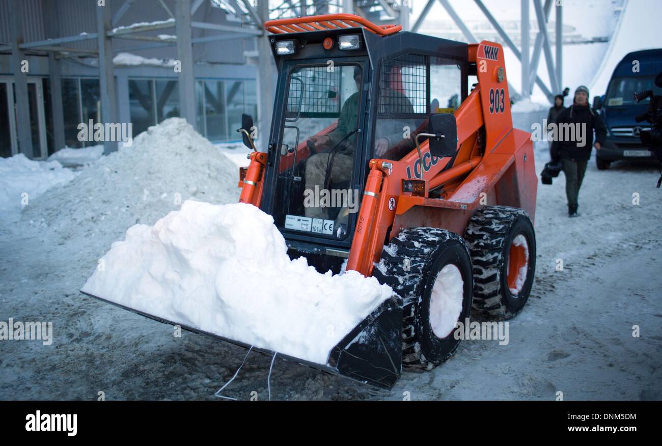 An excavator transports snow at the RusSki Gorki Jumping Center in ...