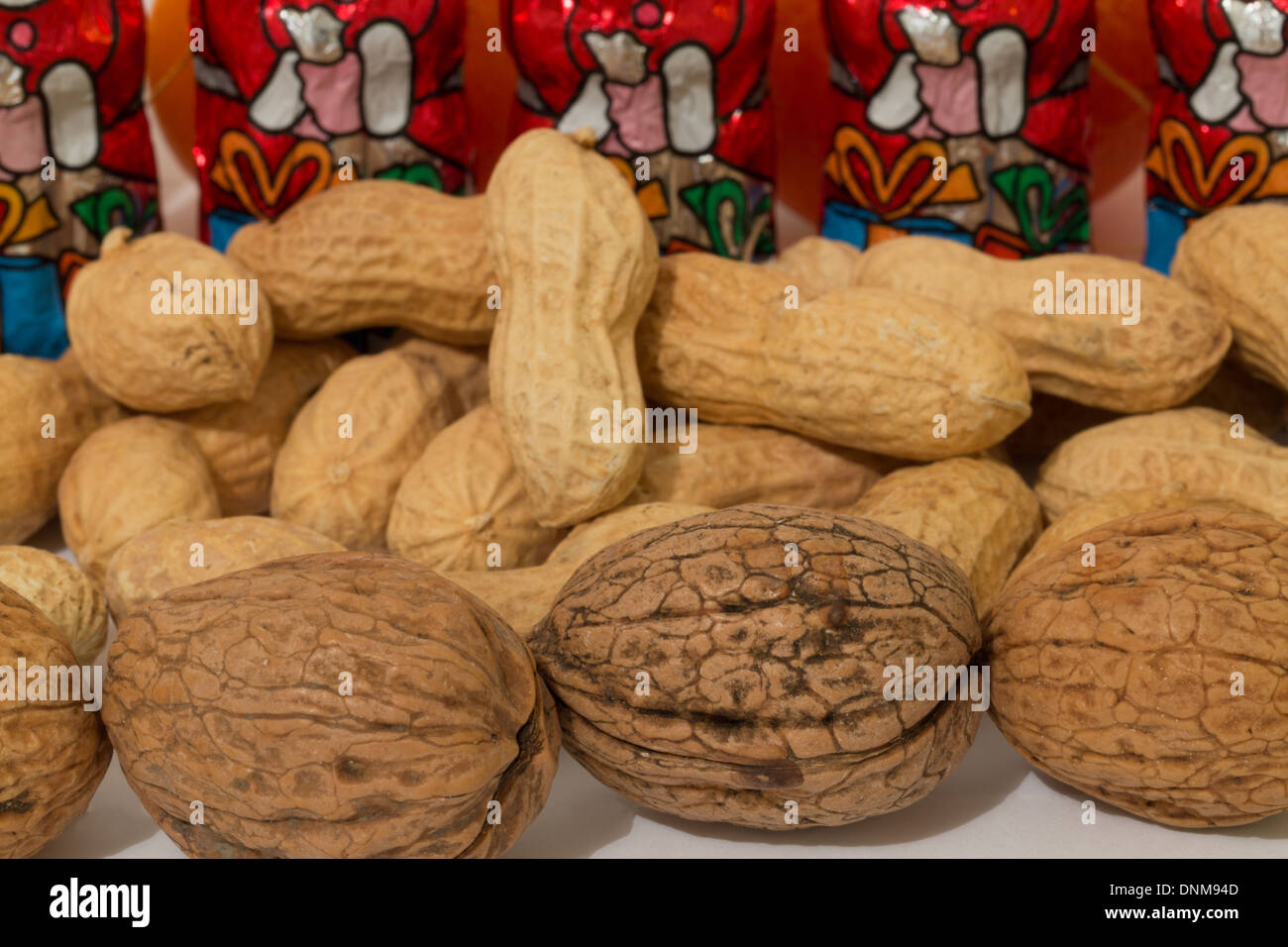 A photograph of some Christmas Santa Claus chocolates, peanuts, and ...