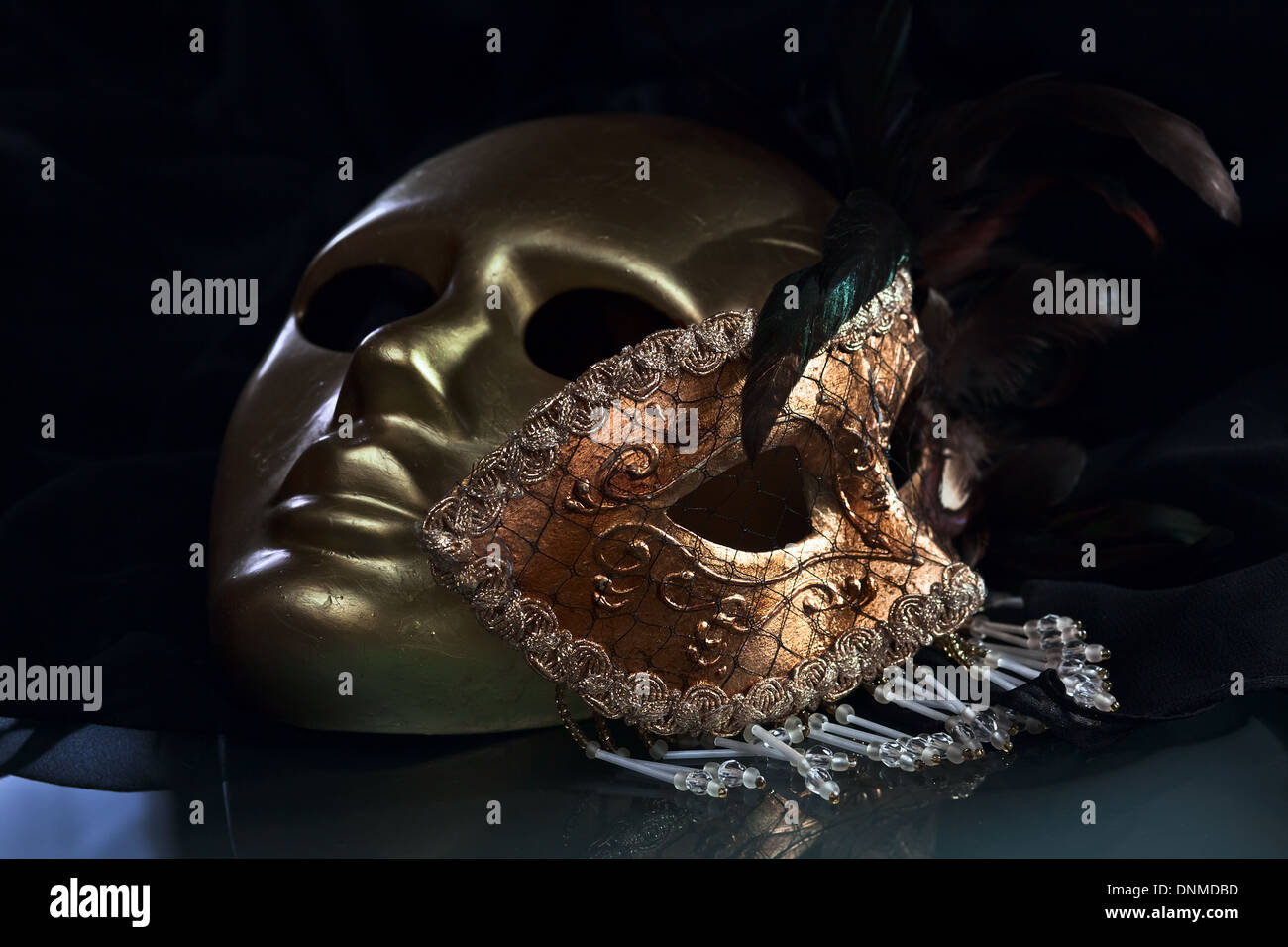 Old gold Venetian masks on a glass table Stock Photo - Alamy