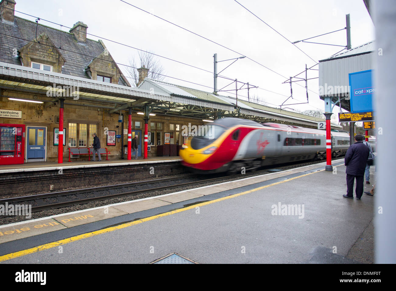 Virgin Train speeding through Oxenholme Lake District railway station ...
