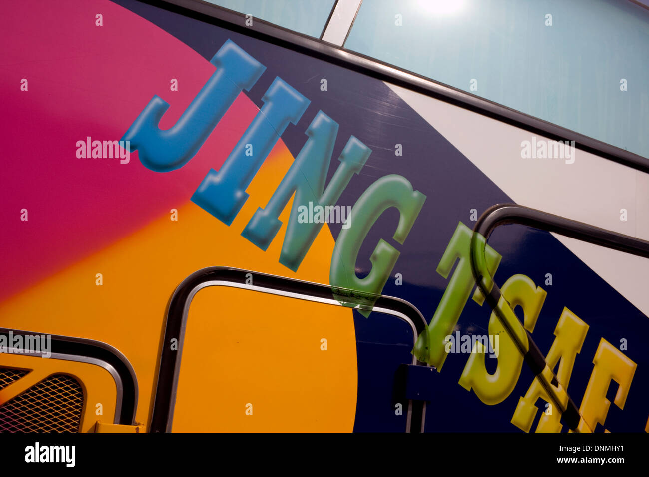A colorful bus is transporting passengers to their destinations from a ...