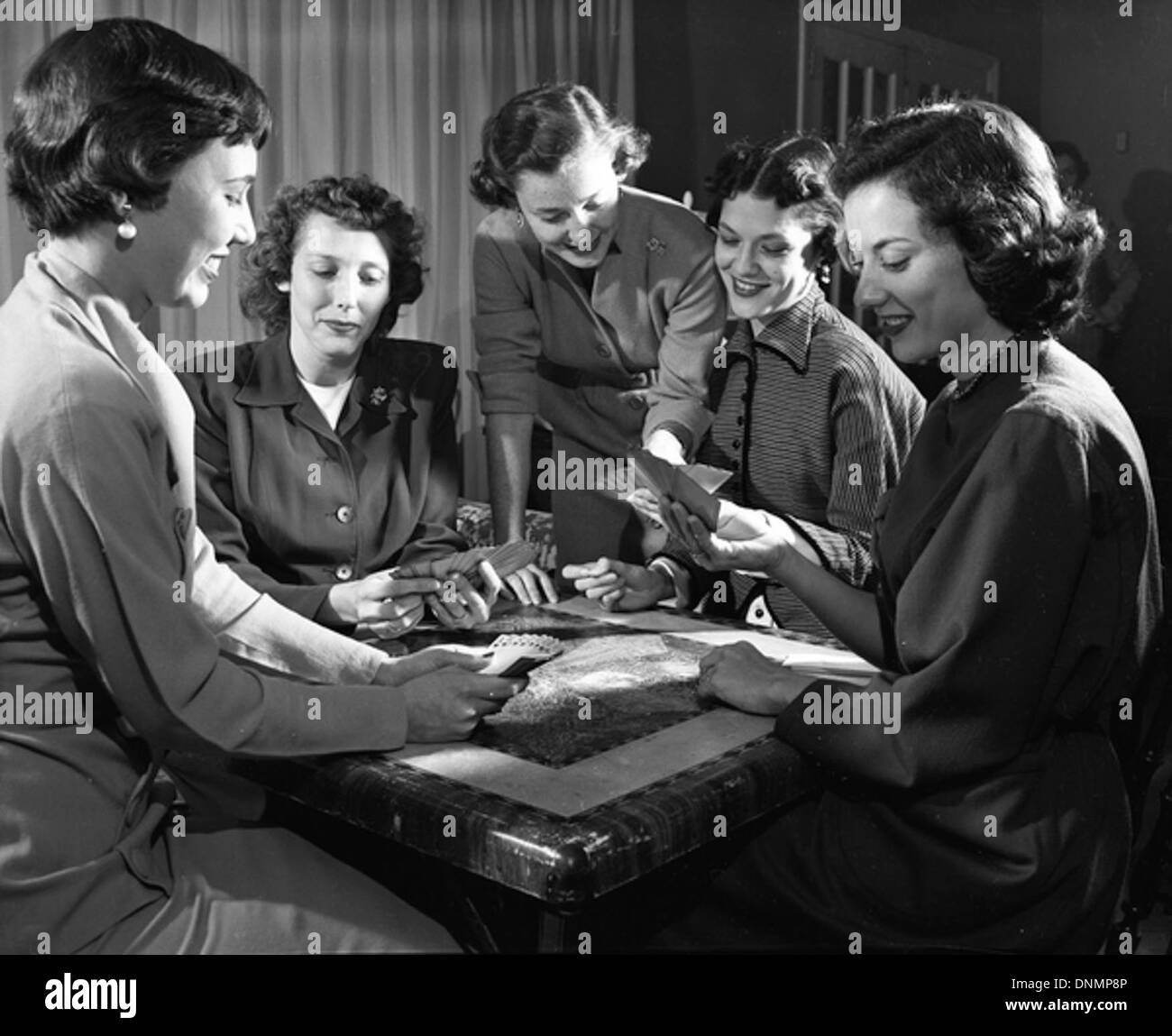 This photograph from the 1950s shows a group of unidentified women ...