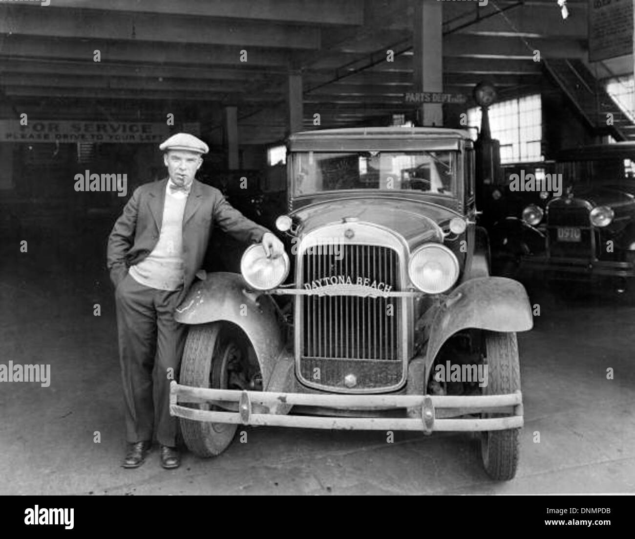 Sig Haugdahl, a notable race car driver, poses with his automobile in ...