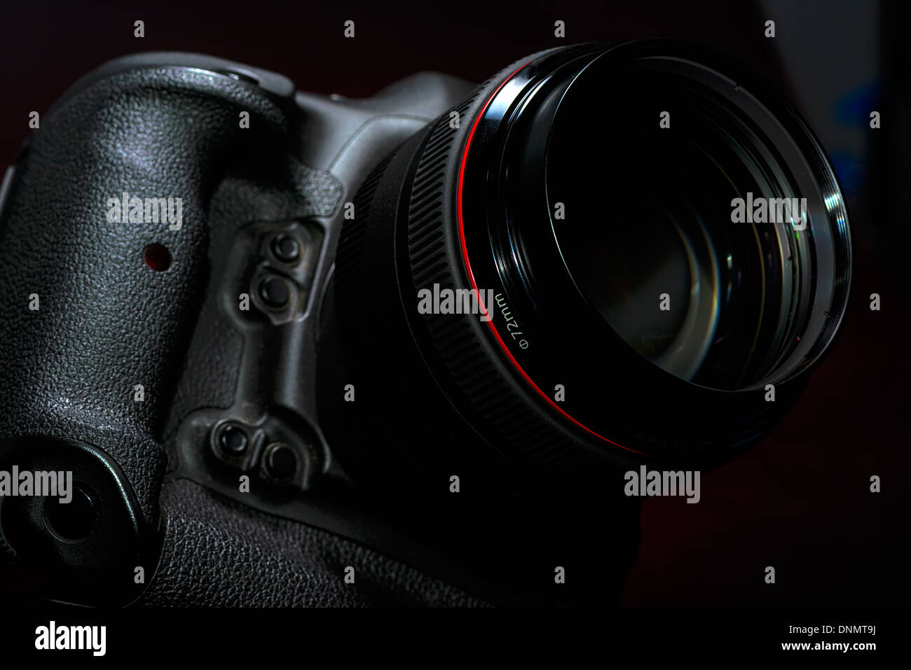 Professional Digital DSLR photo camera on a burgundy background Stock ...