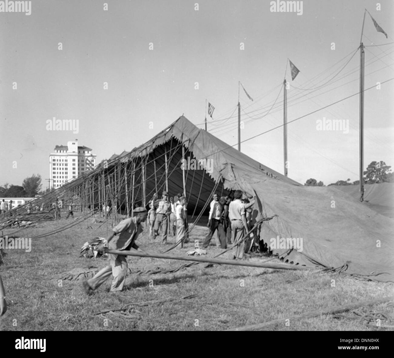 Workers raise the large tent for the final show of the season at the ...