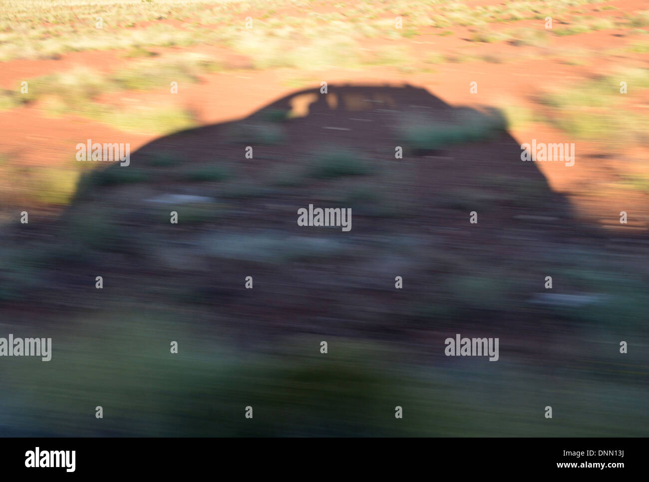 Car shadow as it speeds along a desert road Stock Photo - Alamy