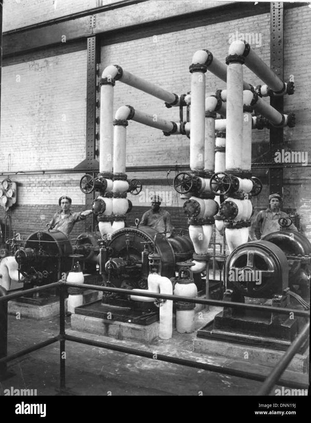 Workers with steam turbines at an industrial site in Tampa, Florida ...