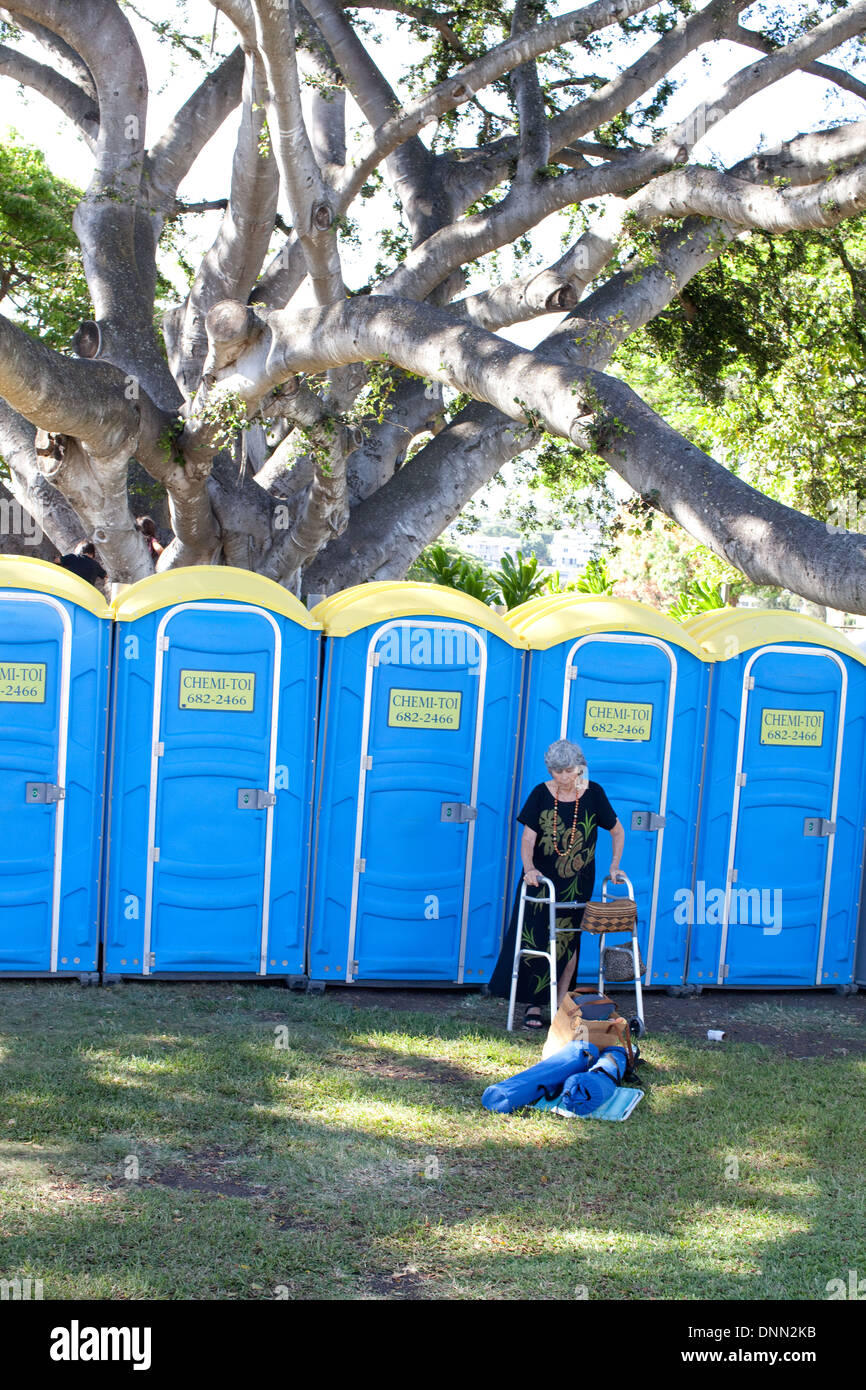 Woman with a walker coming out of portable bathroom Stock Photo - Alamy