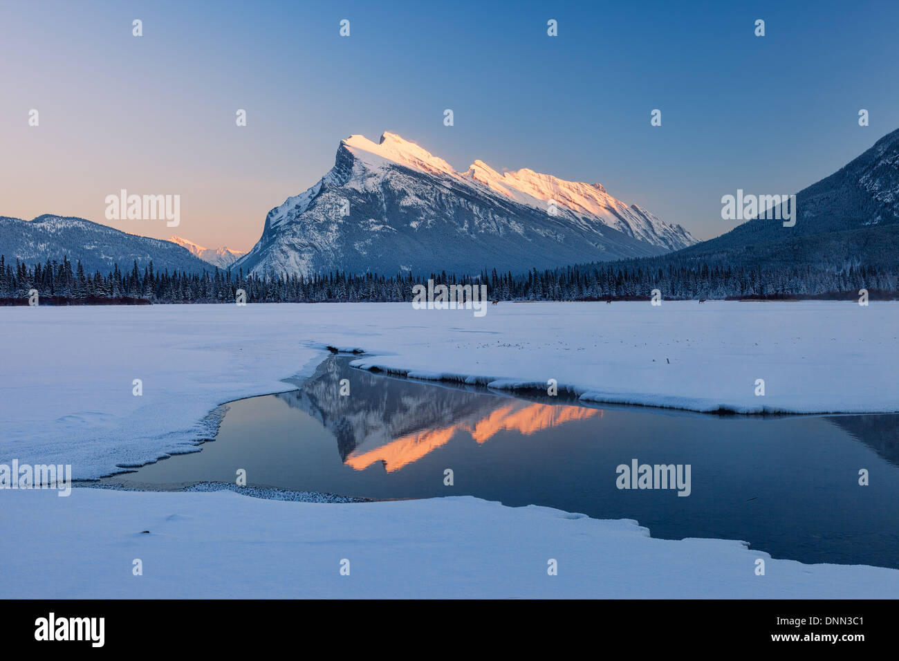 Snow Mountain and Reflection on Partially Frozen Lake Stock Photo - Alamy