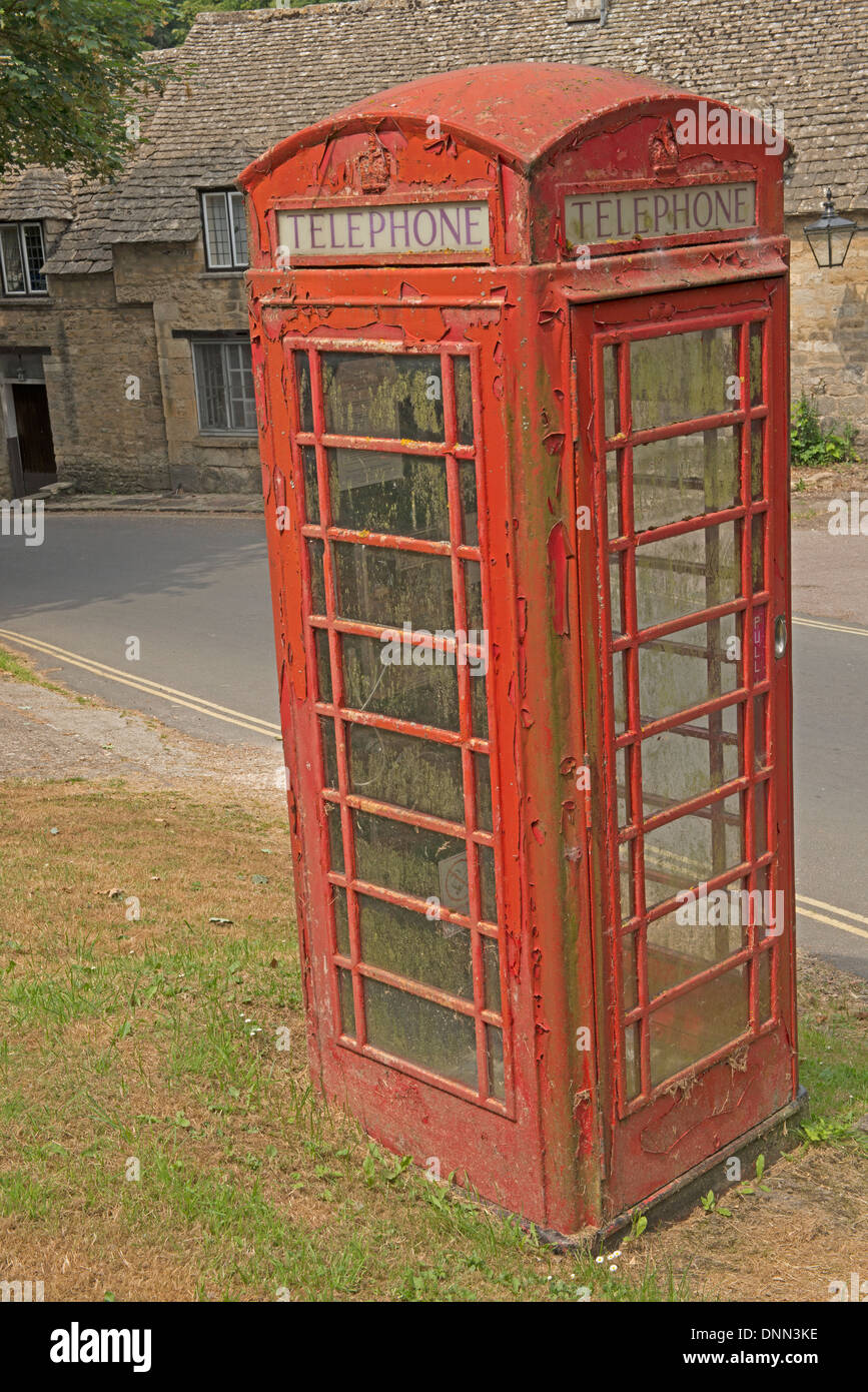 Old red K6 telephone kiosk in the Cotswolds of England. Designed in 1935 by Sir Giles Gilbert ...
