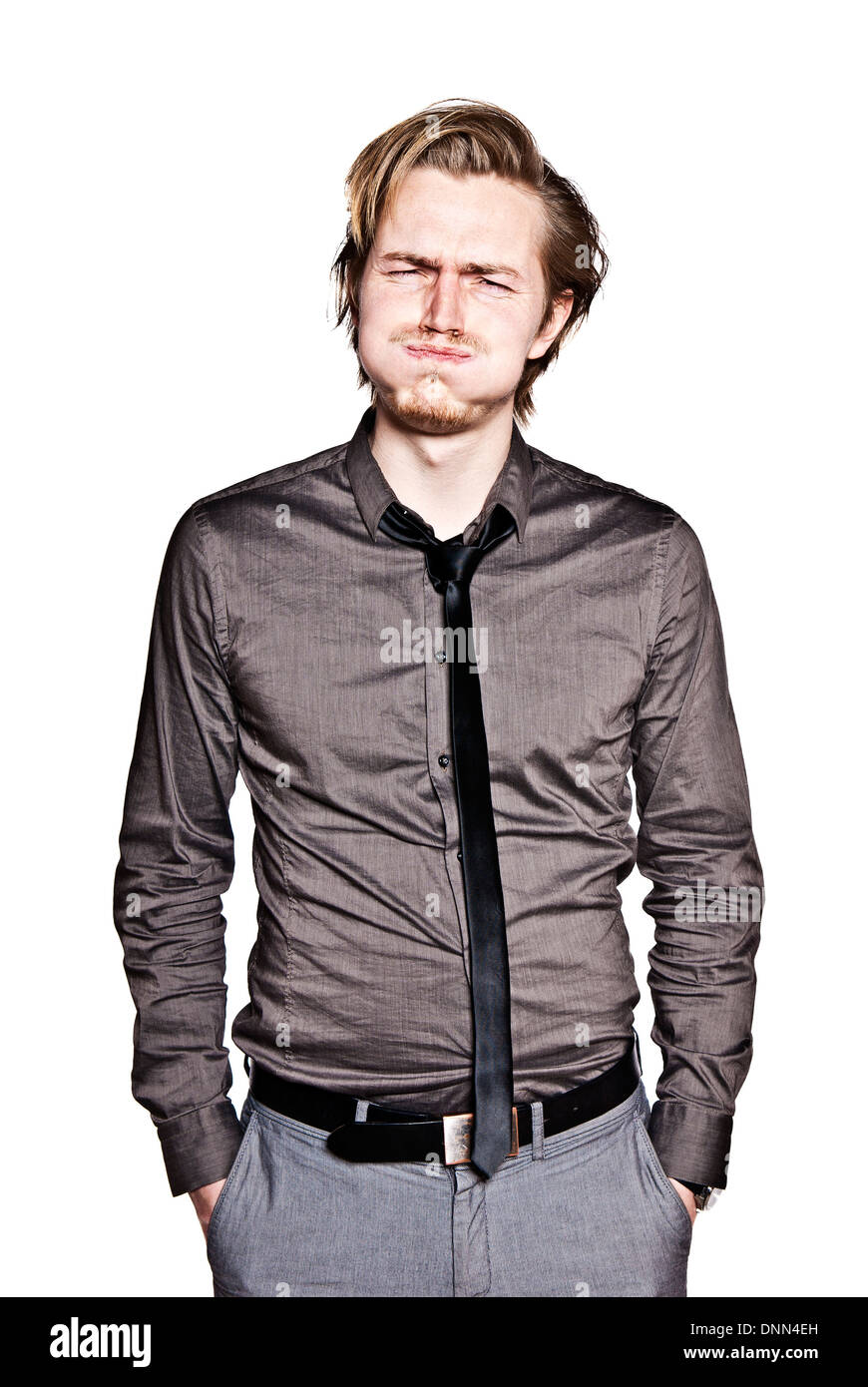 Young man is blowing cheeks. Studio photo of young man making a funny ...