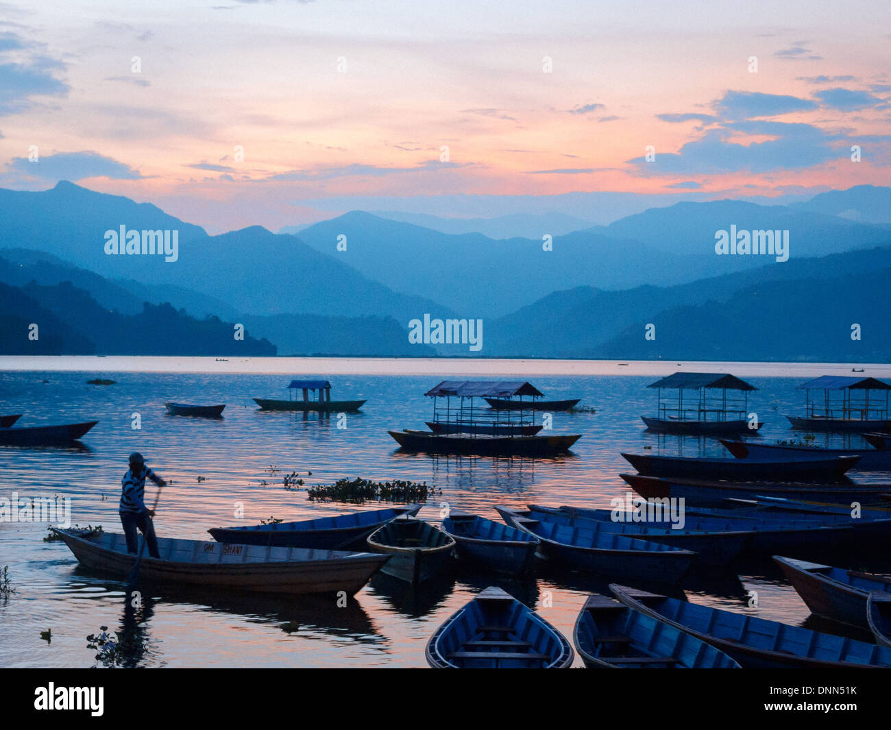 Boats on Fewa Tal at dusk, Pokhara, Nepal Stock Photo - Alamy