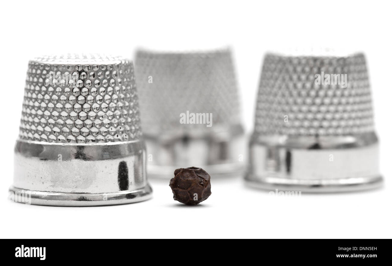 shell game with peppercorn, isolated on white Stock Photo - Alamy