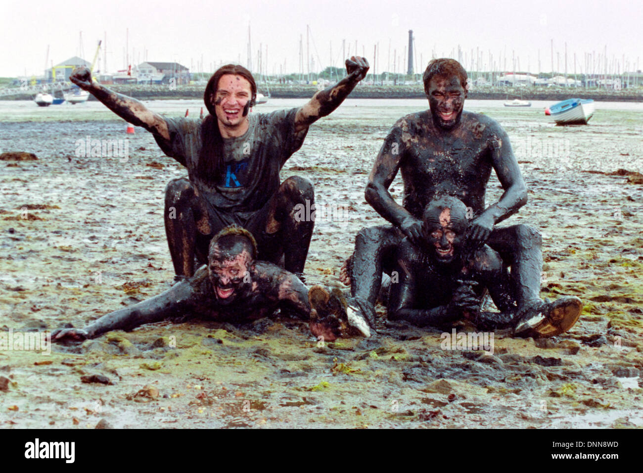 team members pose during traditional game of mud football on langstone ...