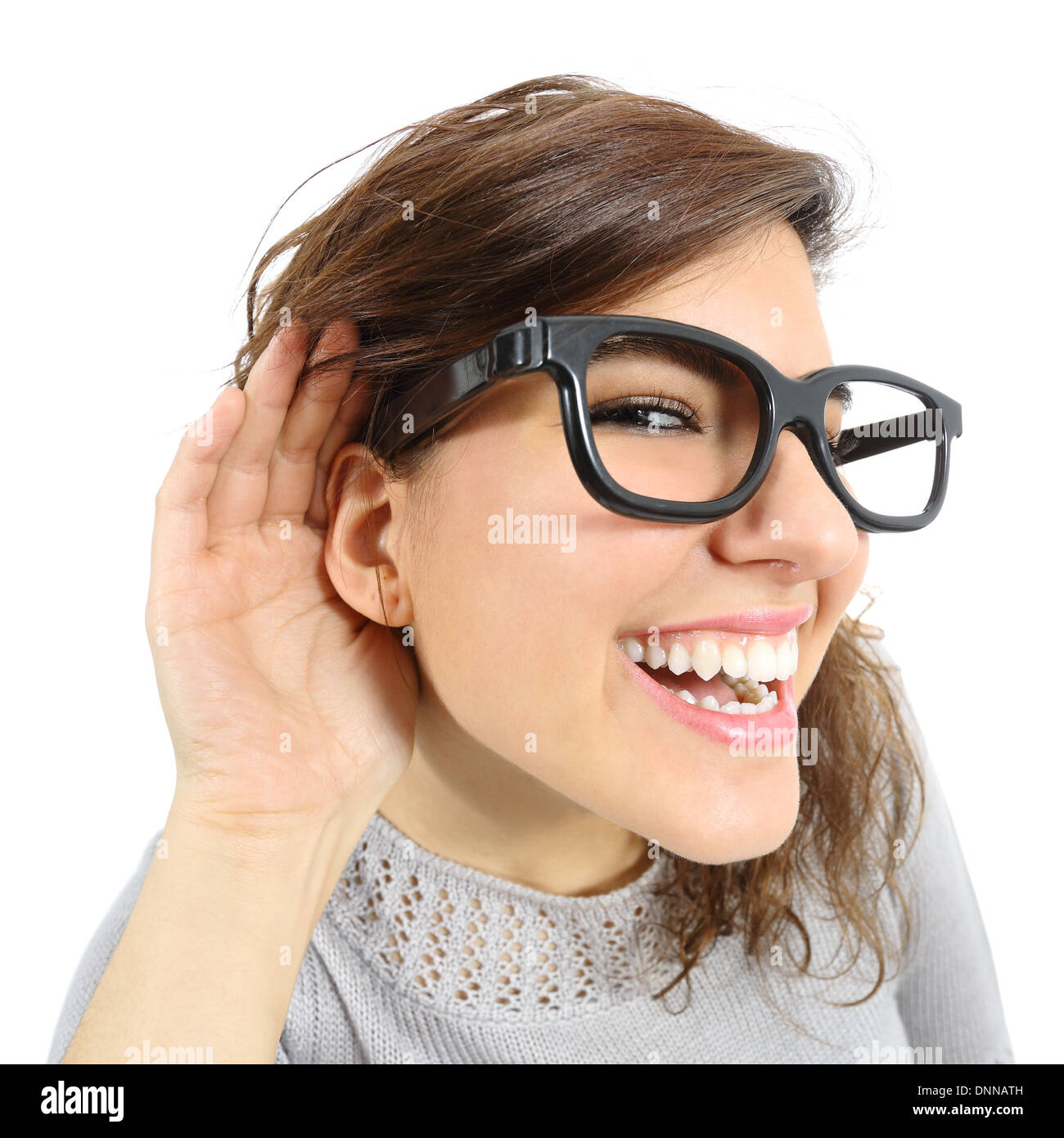 Close up of a woman listening with her hand in the ear isolated on a ...