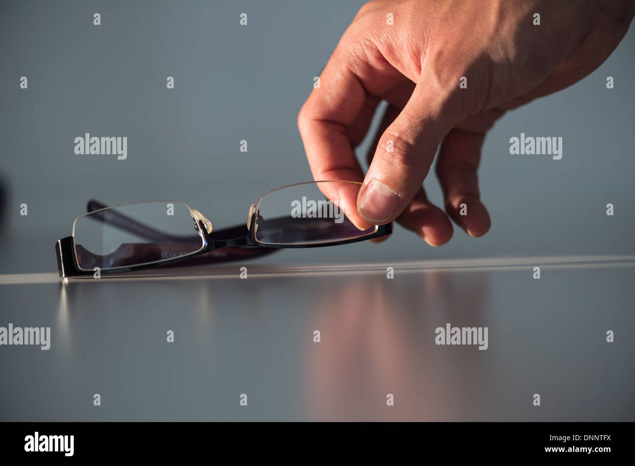 Hand holding eyeglasses hi-res stock photography and images - Alamy