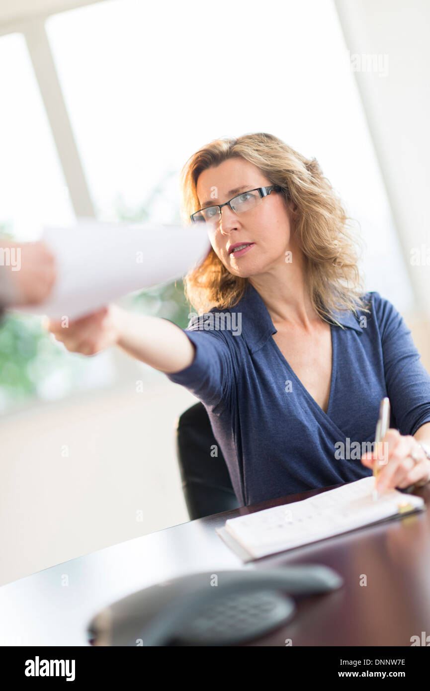 Business people exchanging documents Stock Photo - Alamy