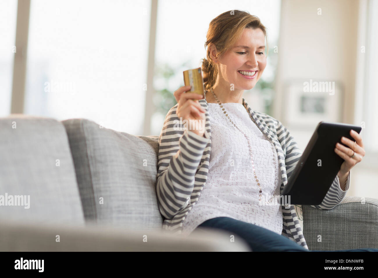 Woman holding tablet credit card hi-res stock photography and images ...