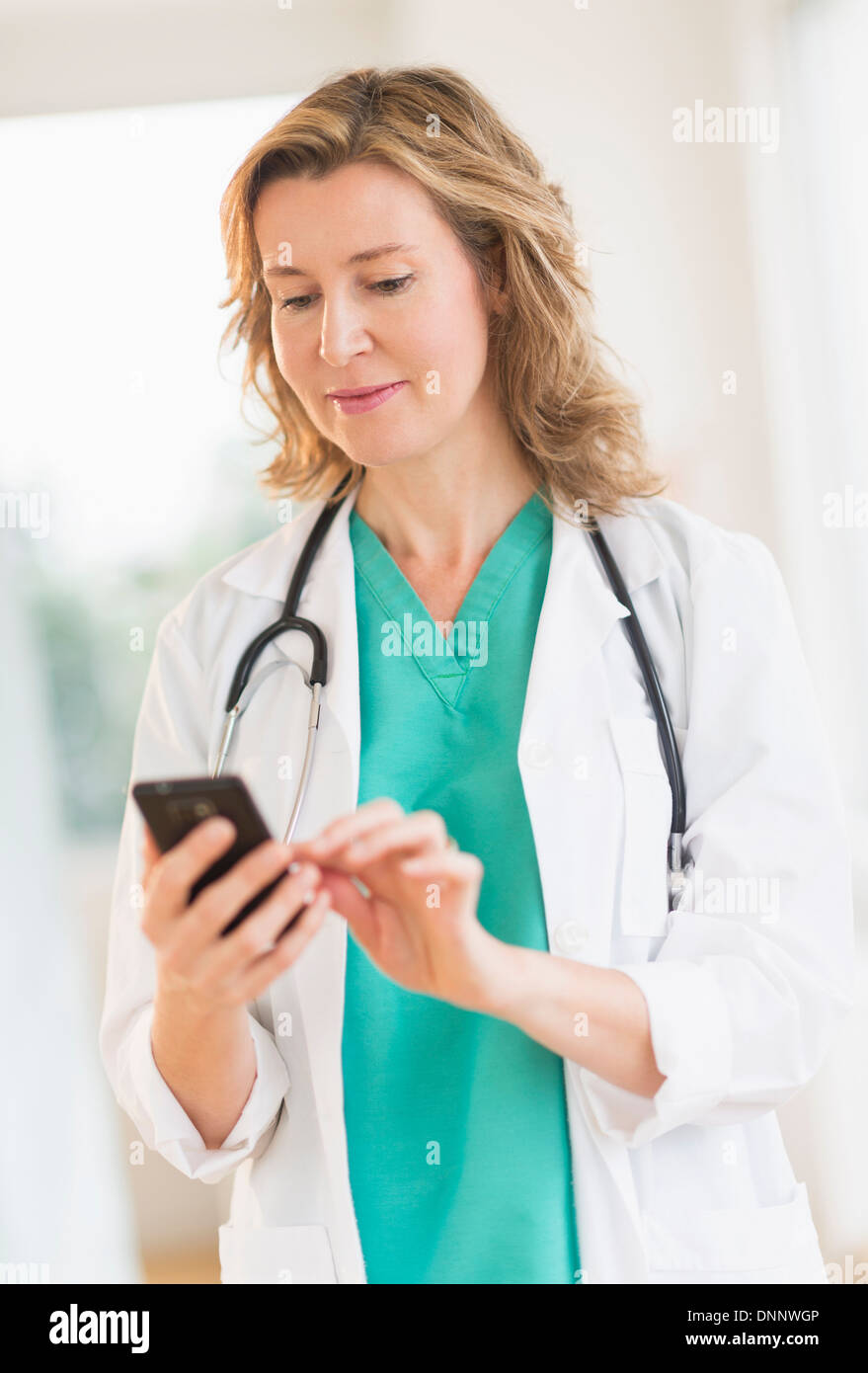 Female doctor using phone Stock Photo - Alamy
