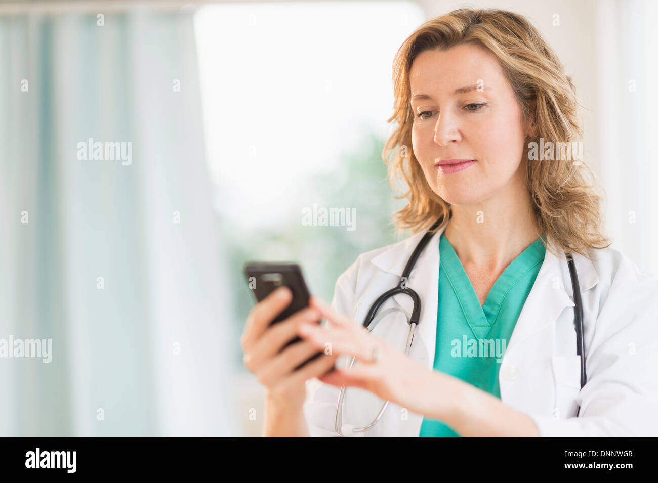 Female doctor using phone Stock Photo - Alamy