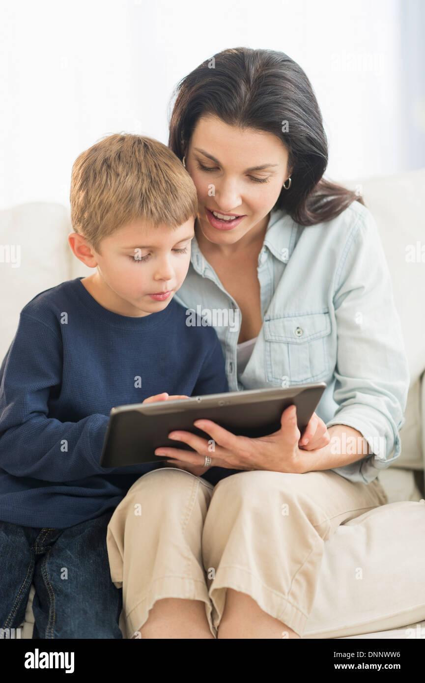 Mother son using tablet hi-res stock photography and images - Alamy