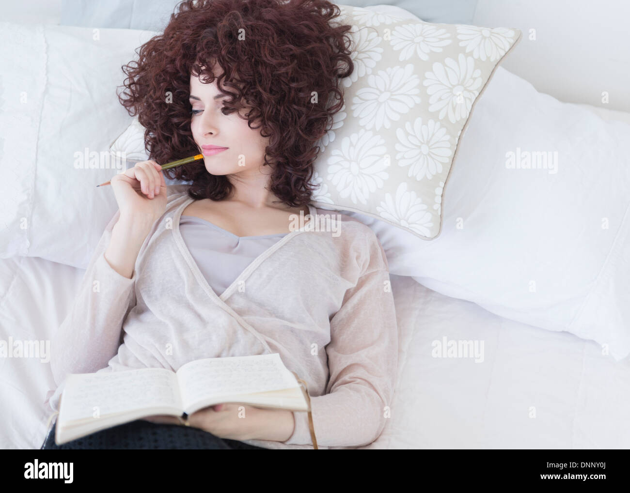 Beautiful woman lying in bed hi-res stock photography and images - Alamy
