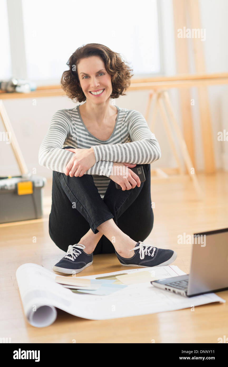Woman sitting on floor arms hi-res stock photography and images - Alamy