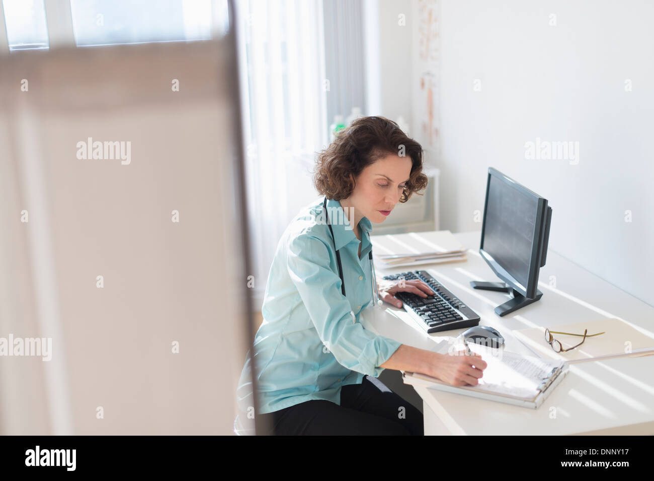 Female doctor doing notes Stock Photo - Alamy