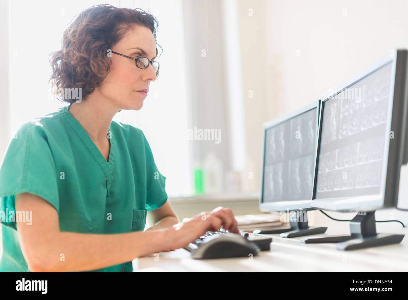 Female technician working on computer Stock Photo - Alamy