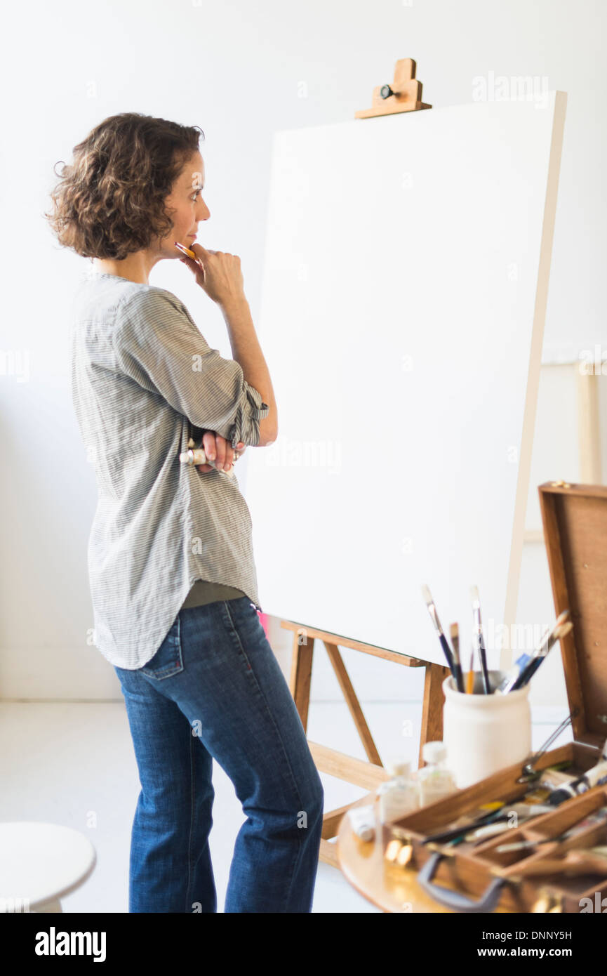 Artist standing in front of canvas Stock Photo - Alamy