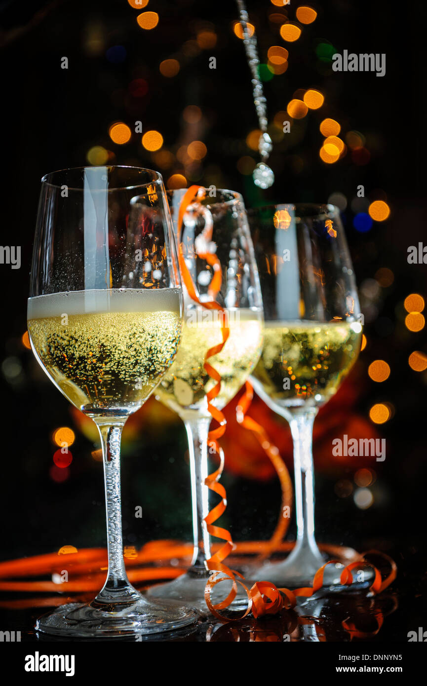 Champagne pouring into three party glasses Stock Photo - Alamy