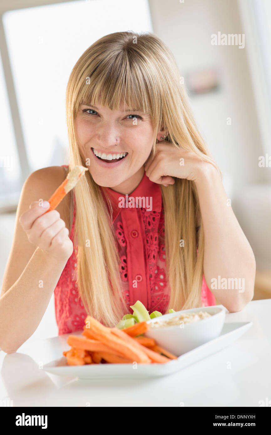 Cheerful woman eating vegetable hi-res stock photography and images - Alamy