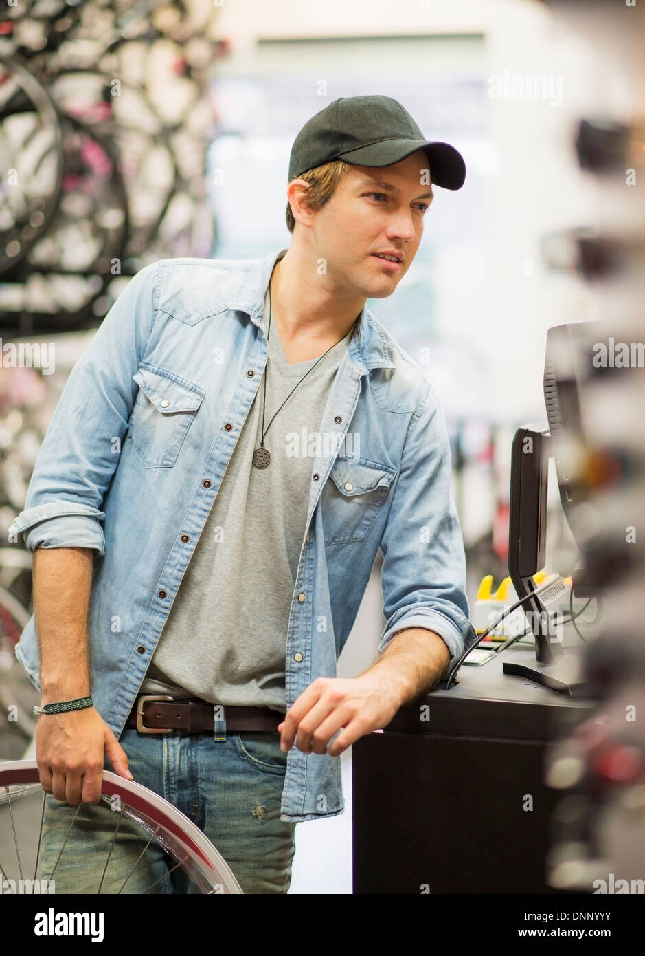 Man in bike shop Stock Photo - Alamy