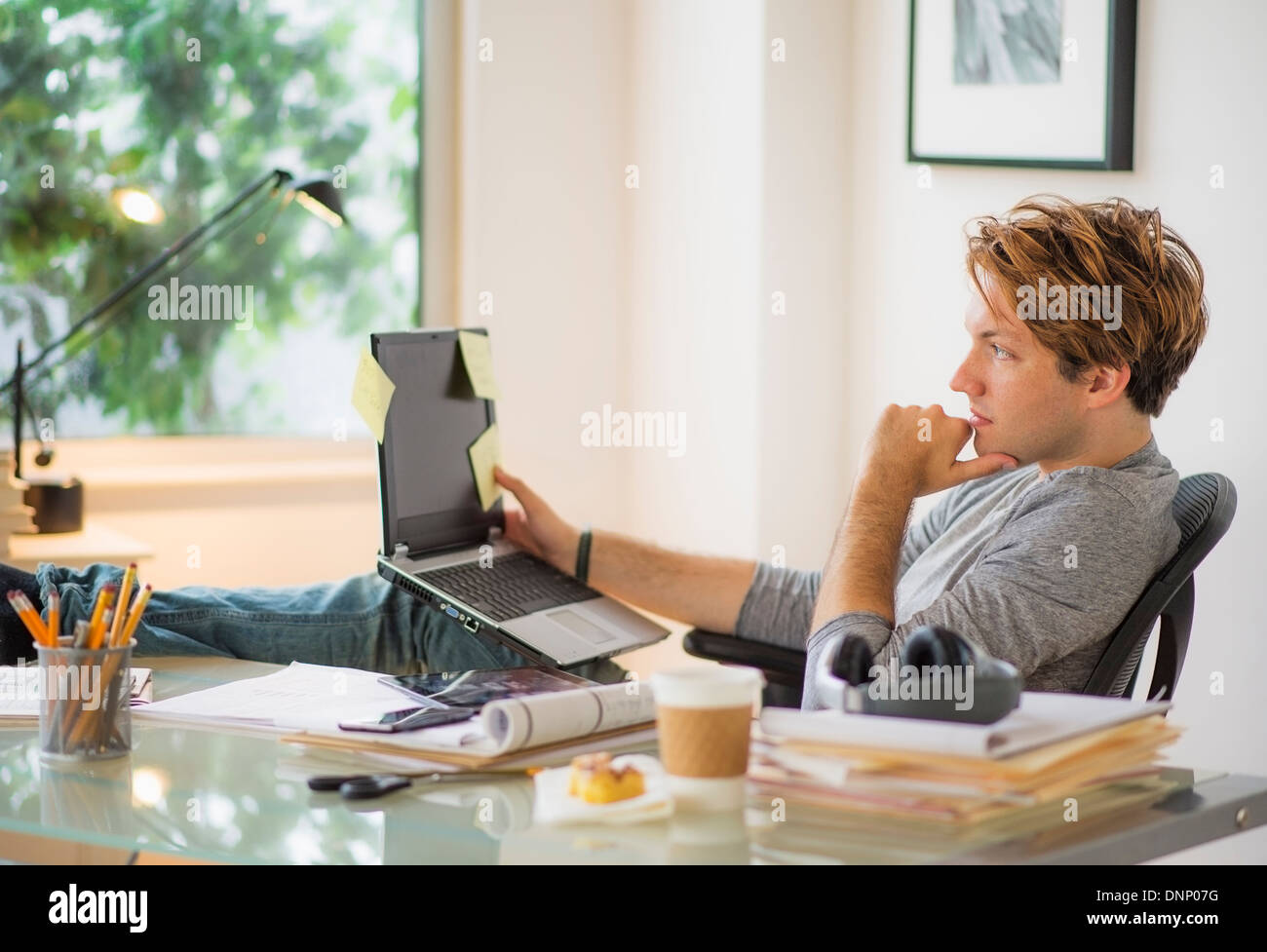 Man using laptop in home office Stock Photo - Alamy