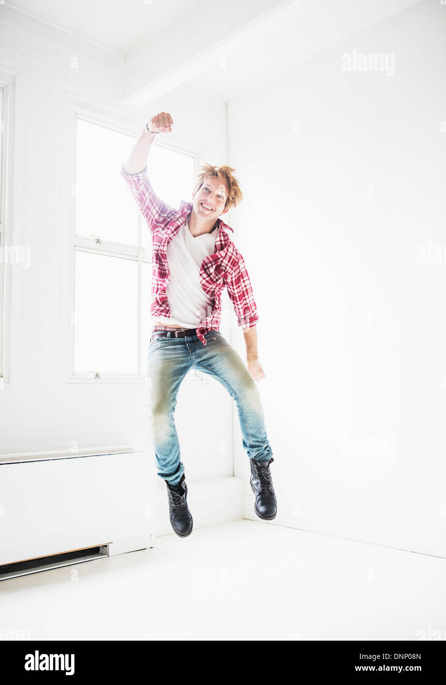Man jumping in room Stock Photo - Alamy