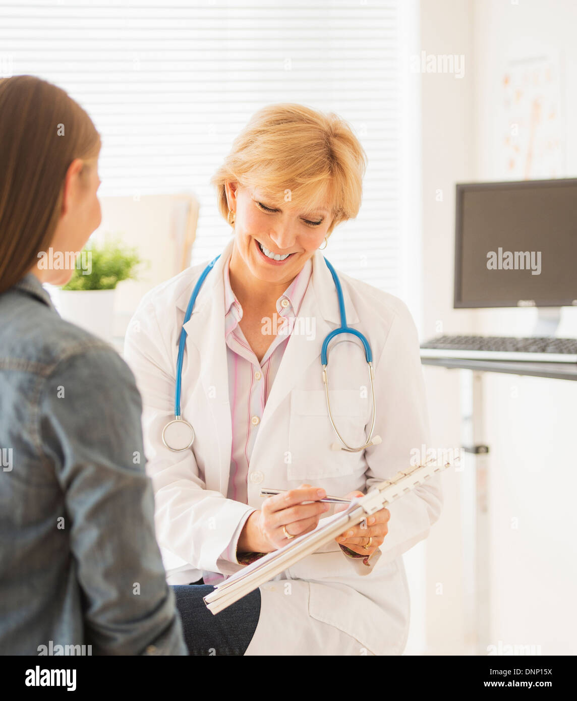Young doctor talking patient showing hi-res stock photography and ...
