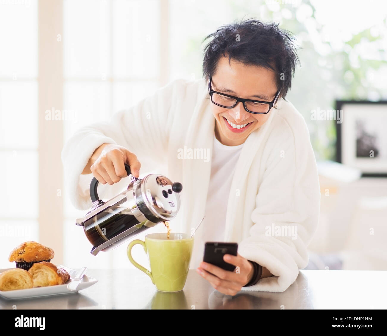 Teenage boy (16-17) eating breakfast Stock Photo - Alamy
