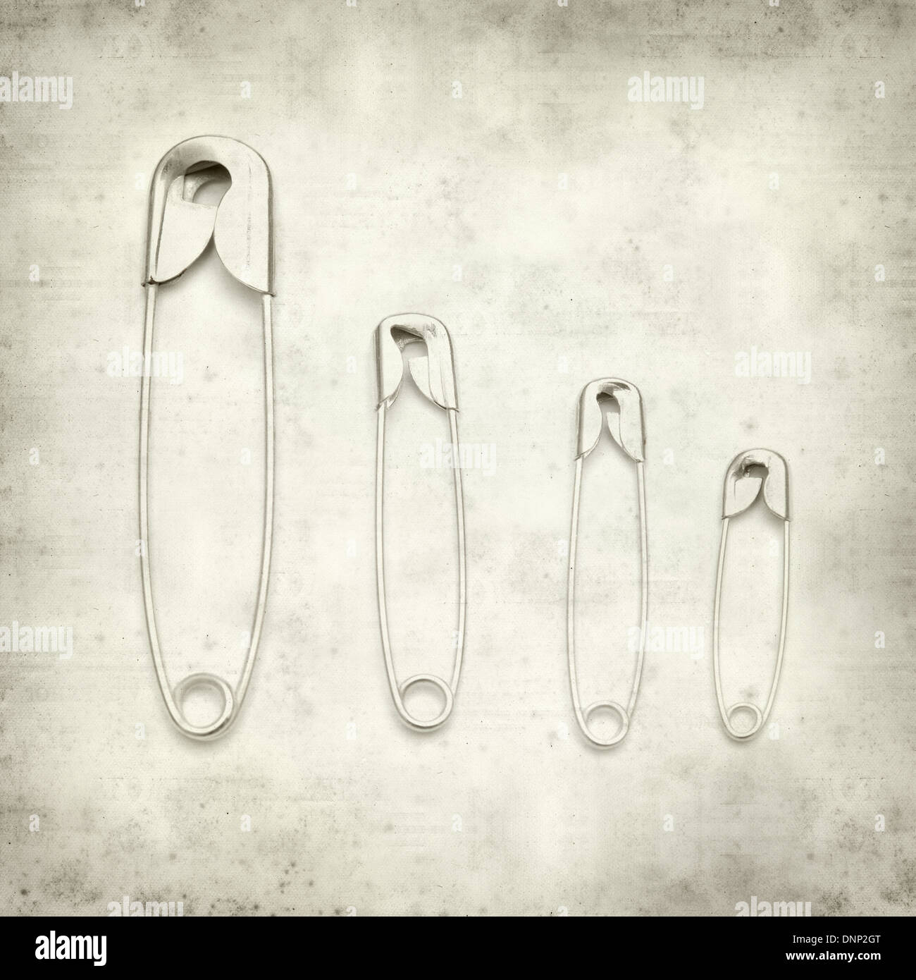 textured old paper background with safety pin Stock Photo - Alamy