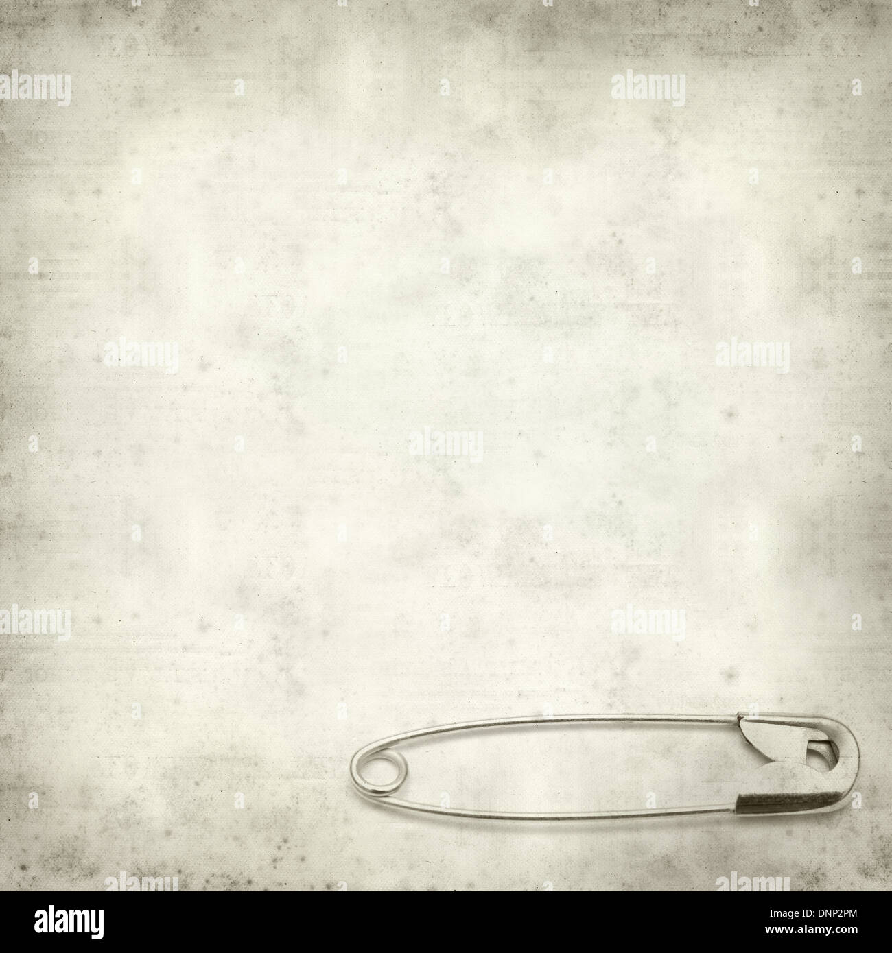 textured old paper background with safety pin Stock Photo - Alamy