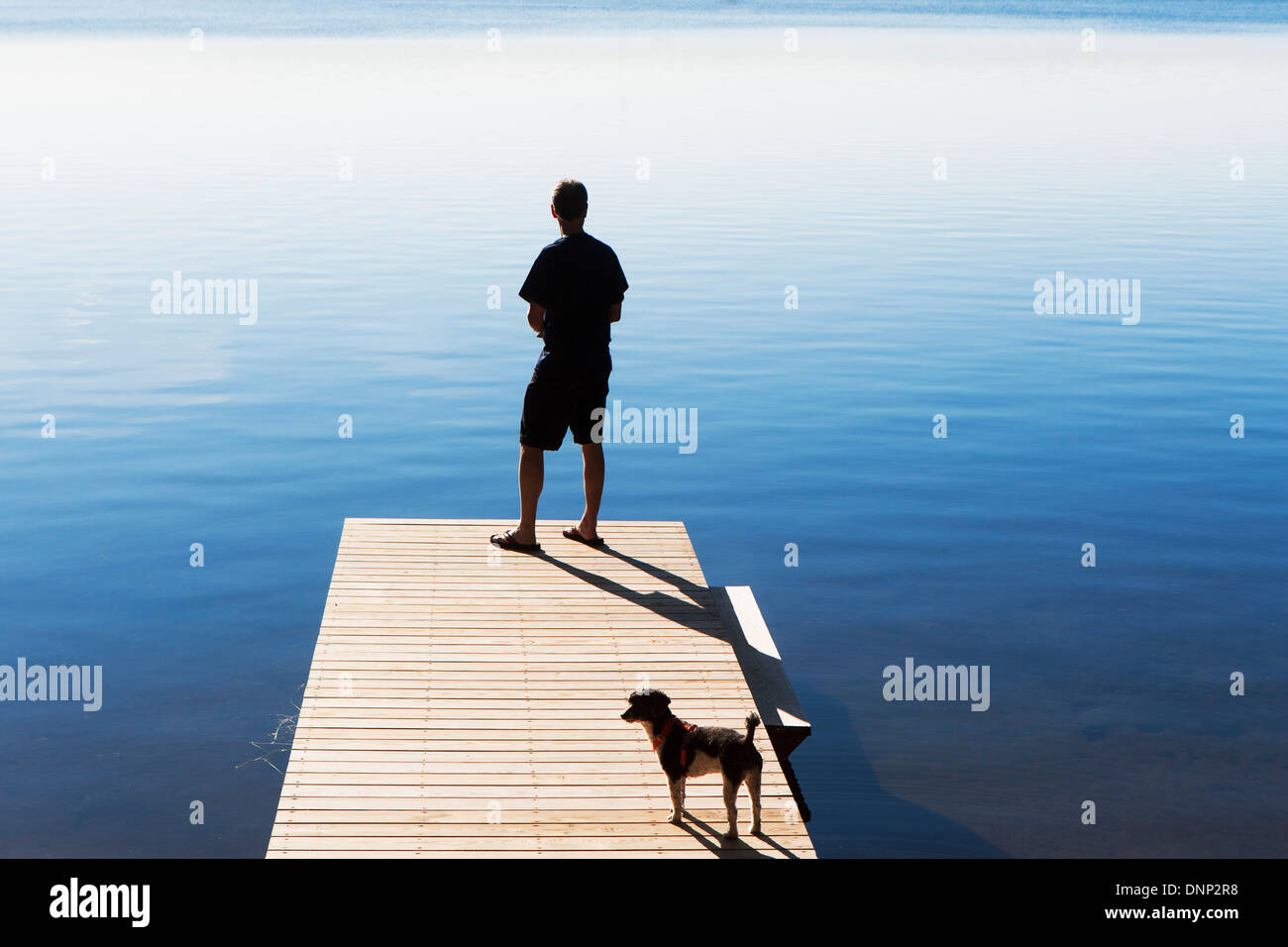 Man standing jetty looking lake hi-res stock photography and images - Alamy