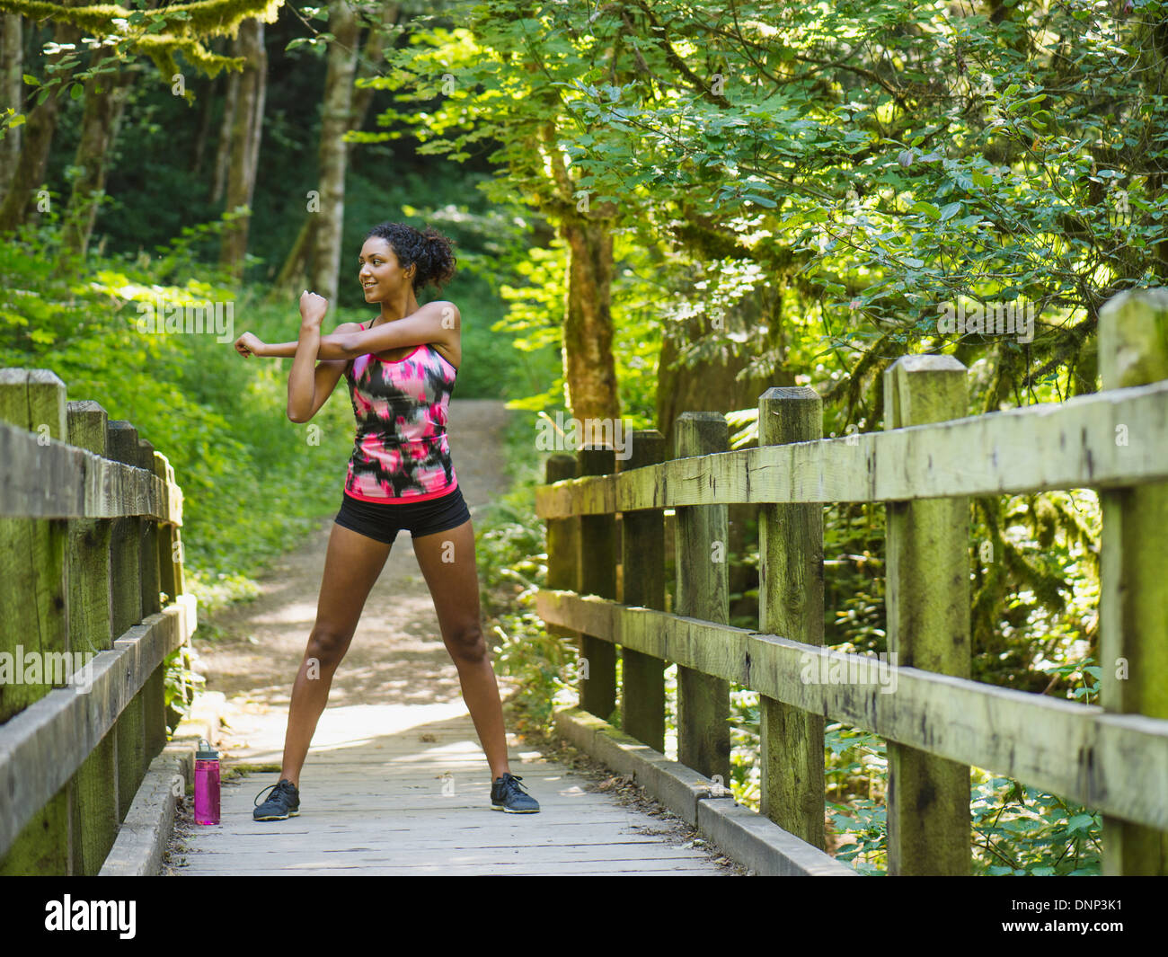 USA, Oregon, Portland, Young women stretching on footbridge Stock Photo ...